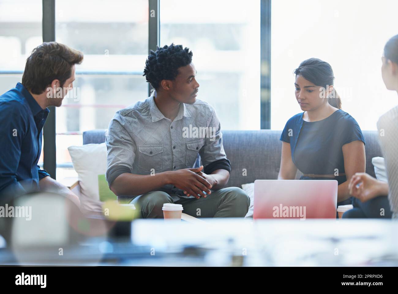 Taking a few follow-up questions. a group of office workers talking ...