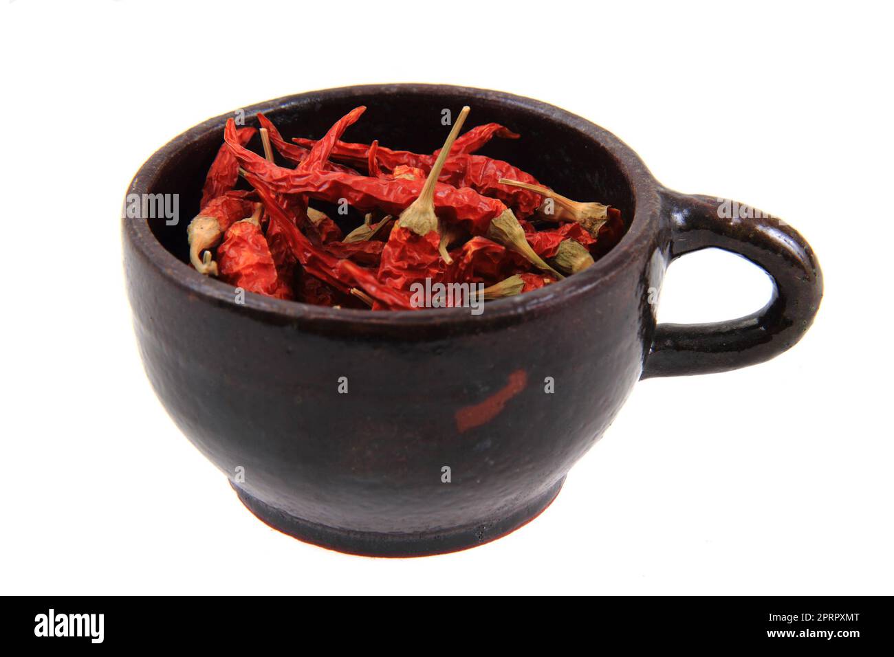 chilli pepper in old cup isolated on the white background Stock Photo ...