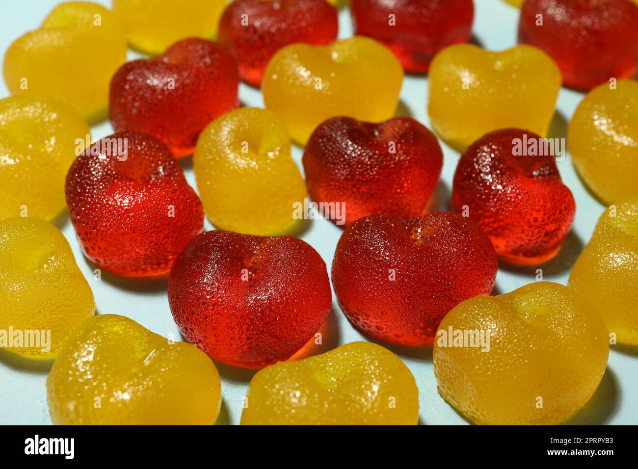 Delicious gummy cherry candies on light blue background, closeup Stock ...