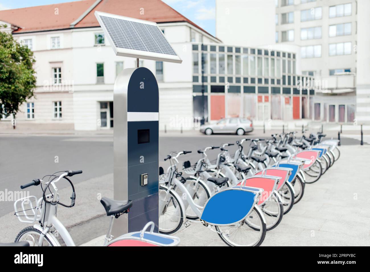 Station with solar panel and many bicycles on city street. Bike rental ...