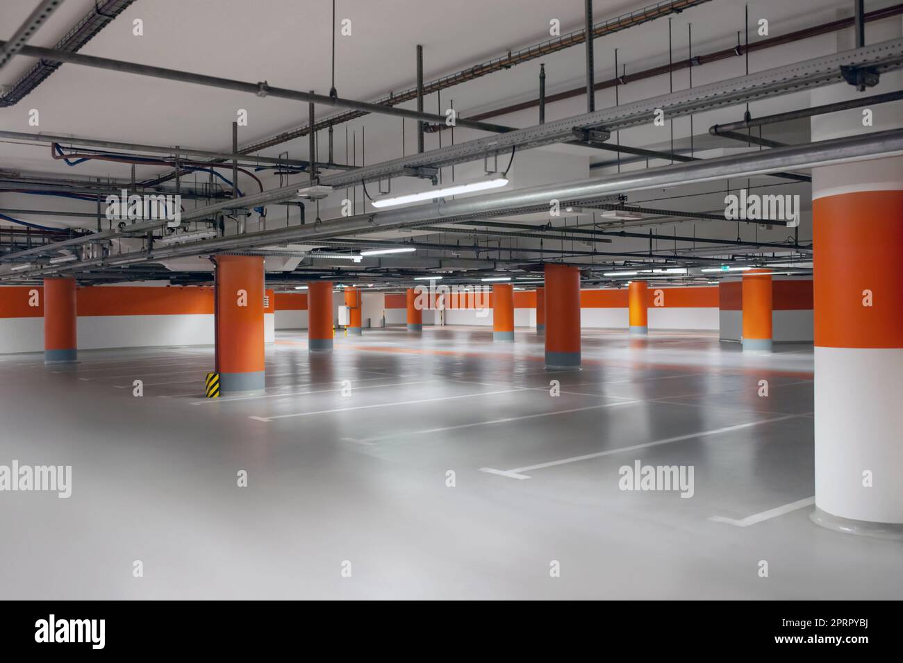 Empty car parking garage with lighting and columns Stock Photo - Alamy