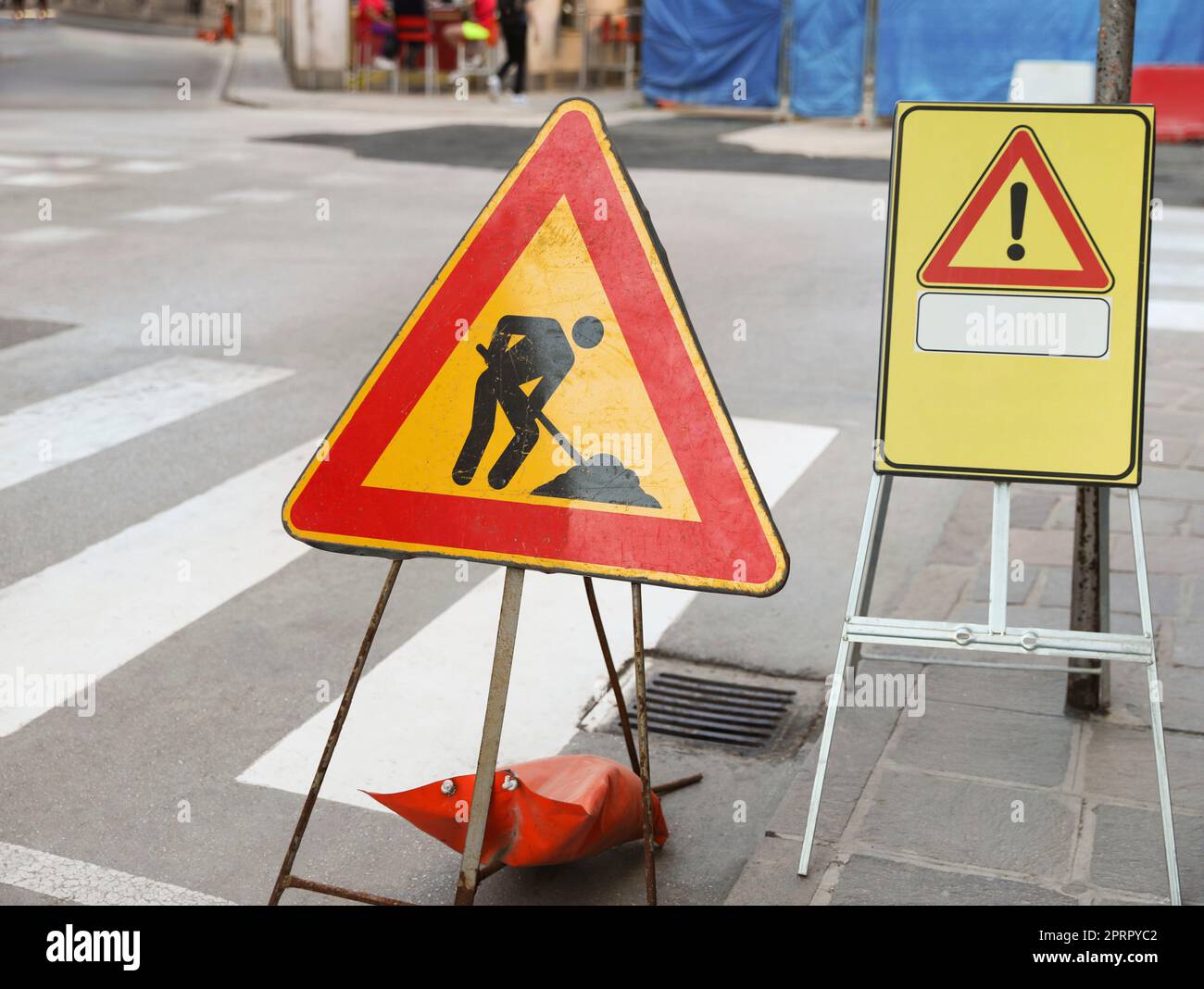 Different traffic signs near pedestrian crossing on city street Stock ...