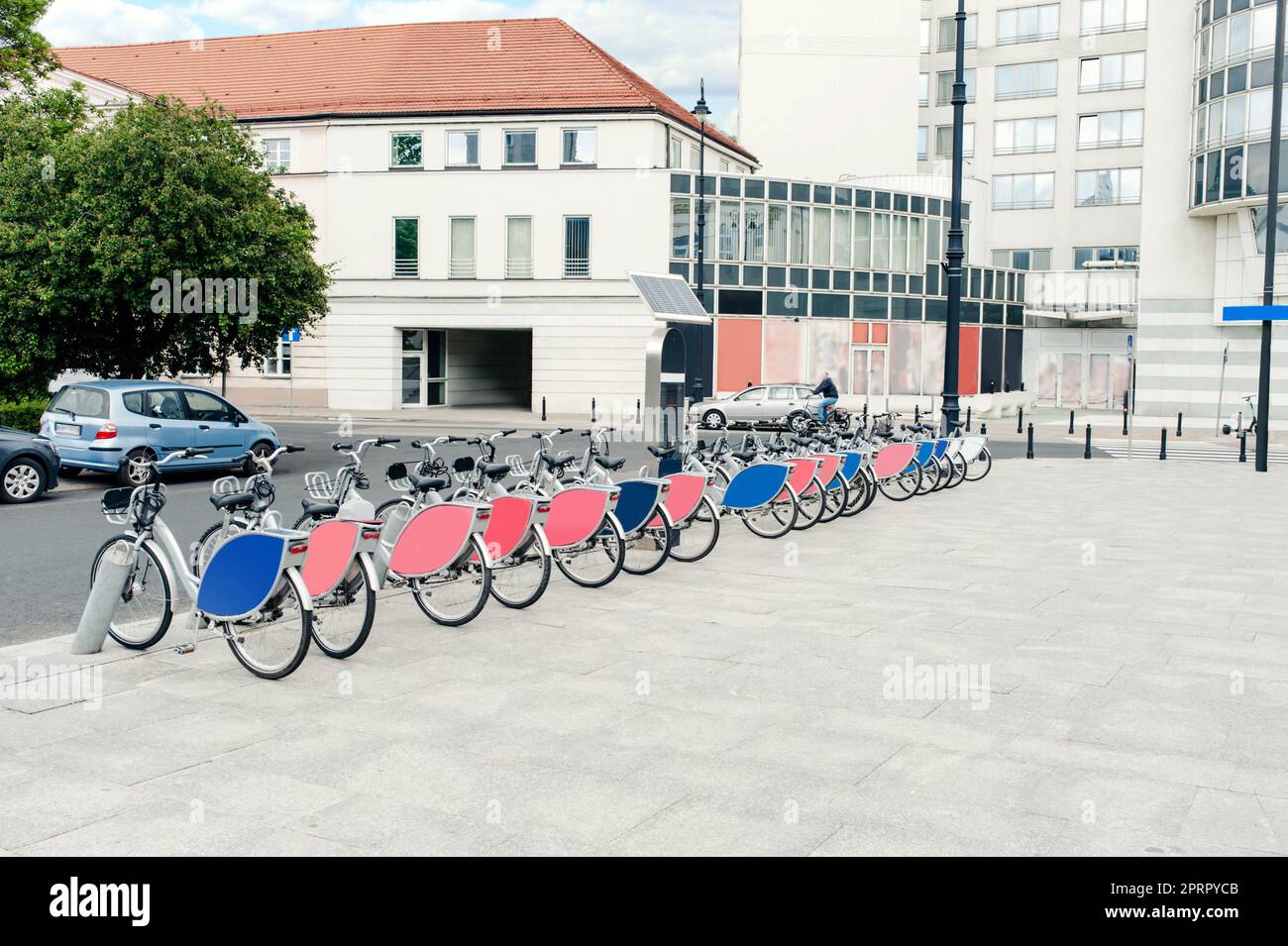 Many bicycles and station on city street. Bike rental fleet Stock Photo ...