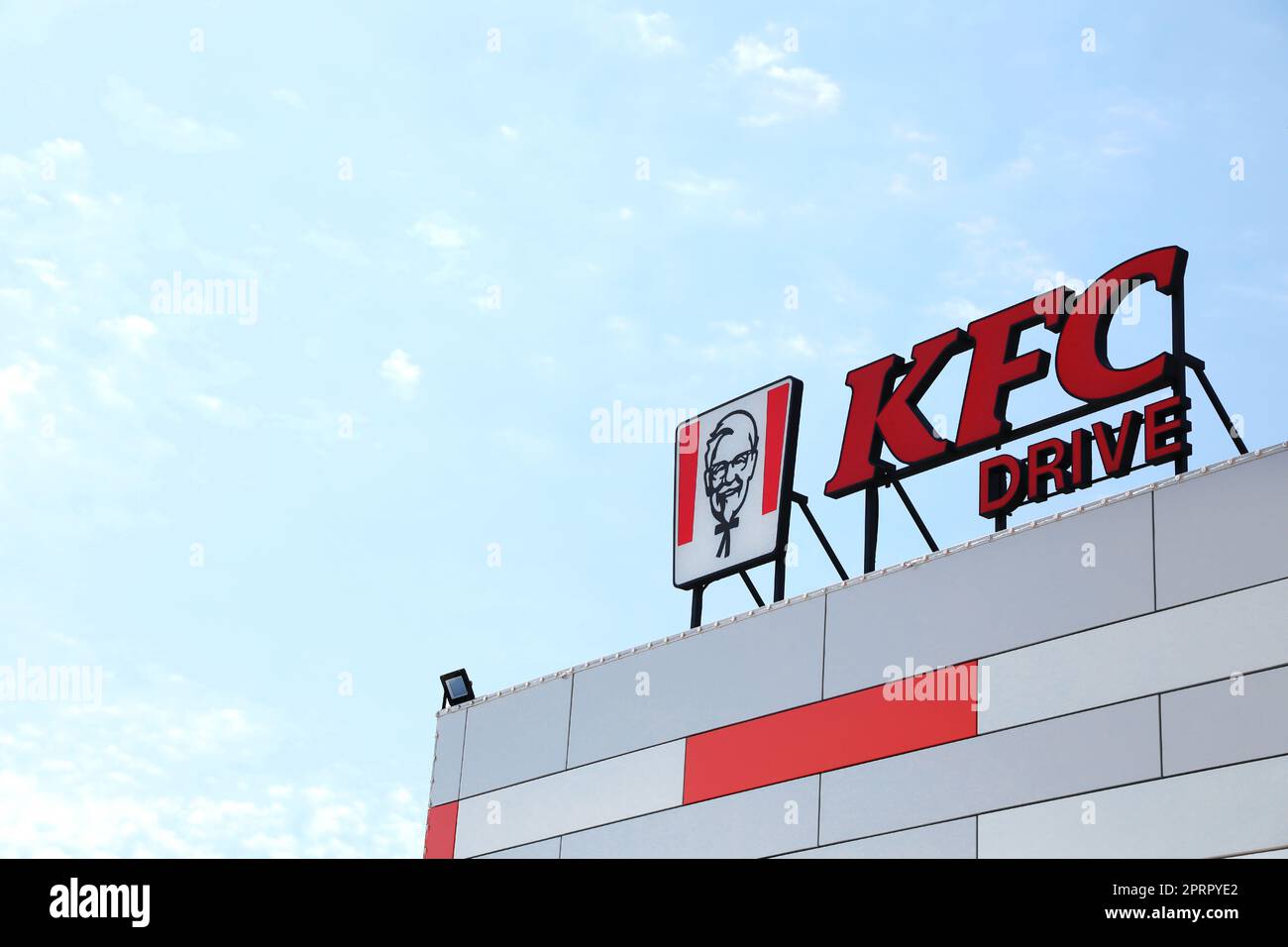 Lviv, Ukraine - May 1, 2022: Modern building with KFC logo against blue ...