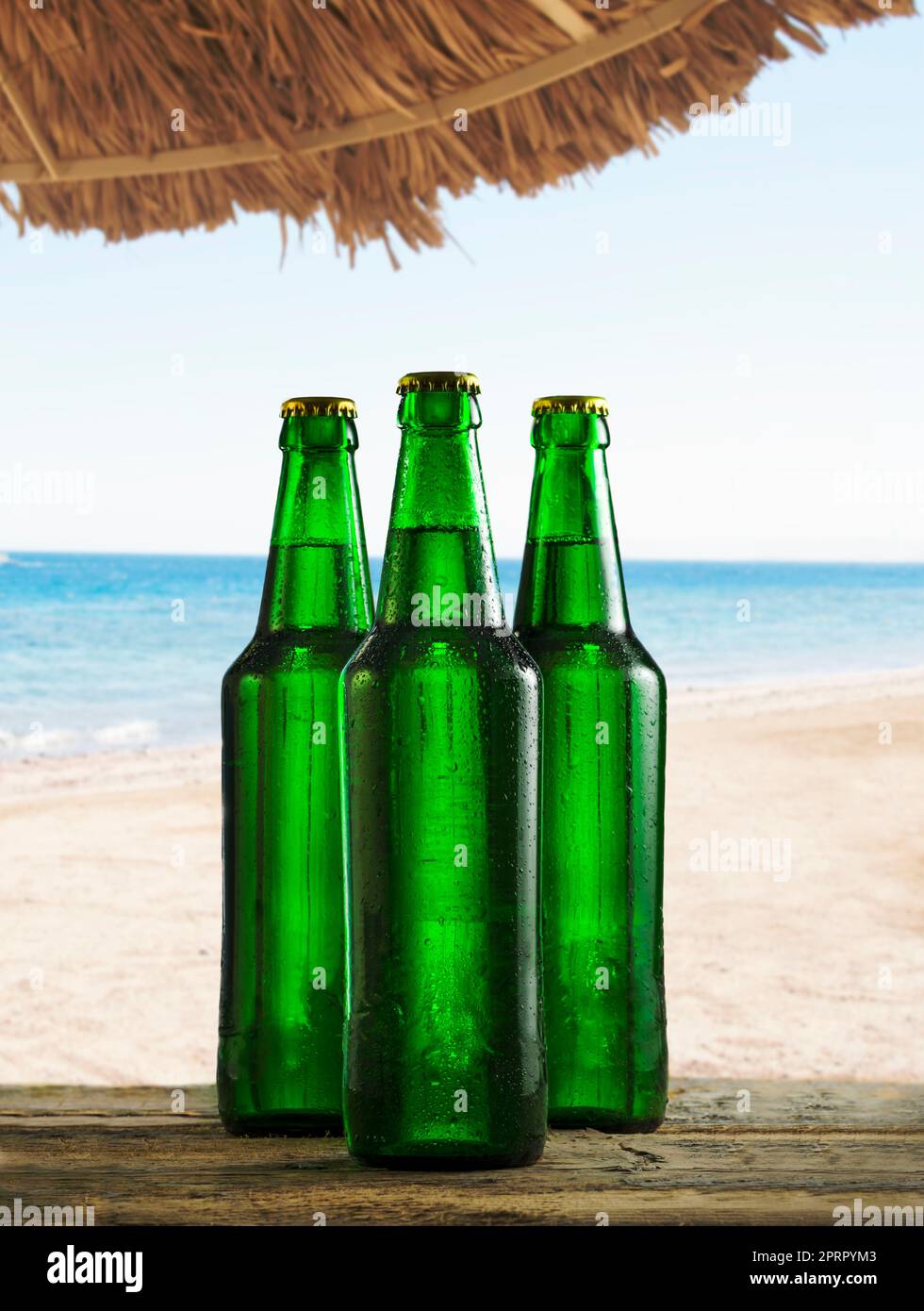 Refreshing Cold Beer Bottles On Beach Bar Table With Water Drops
