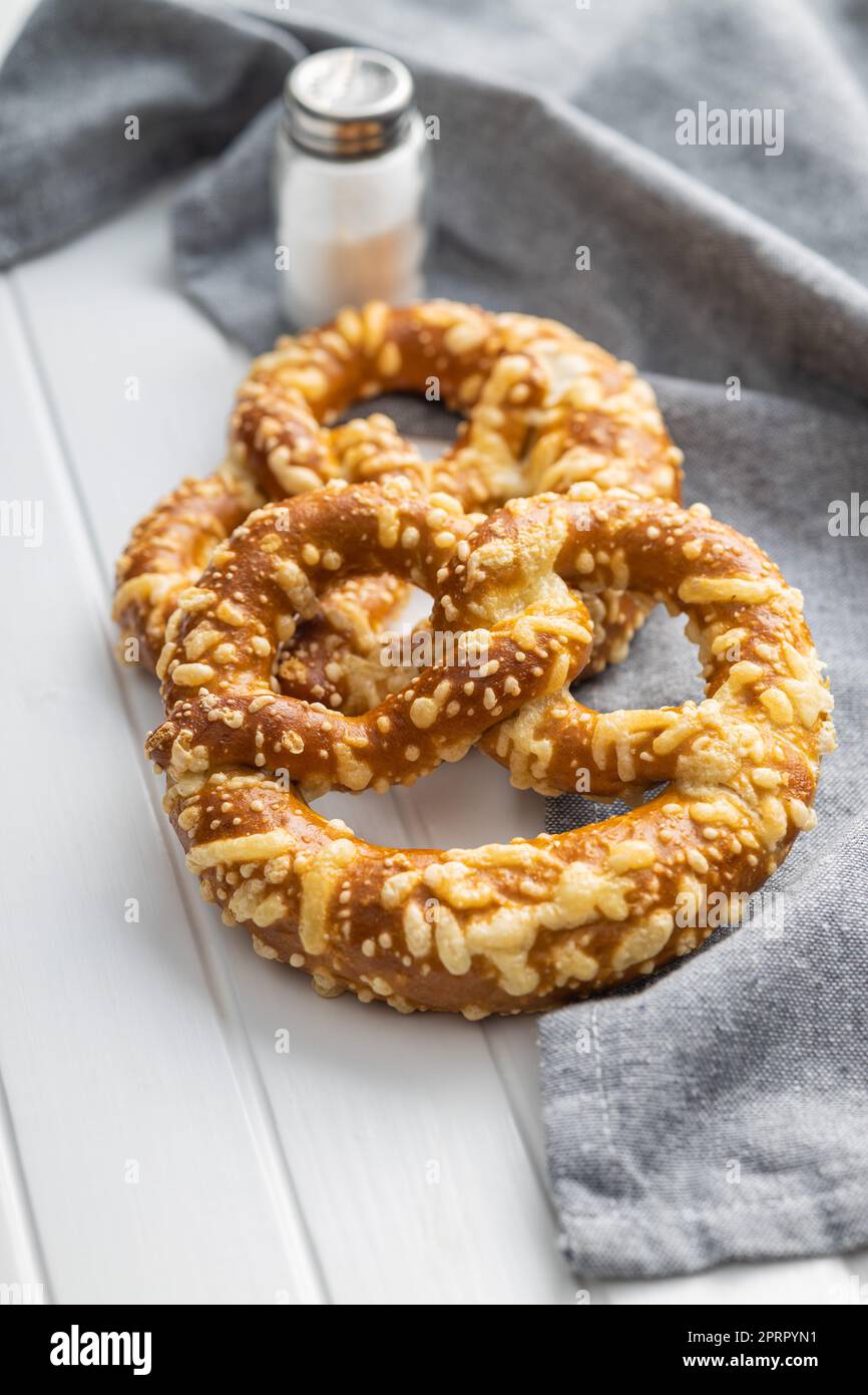 German bread pretzel with baked cheese on kitchen table Stock Photo - Alamy