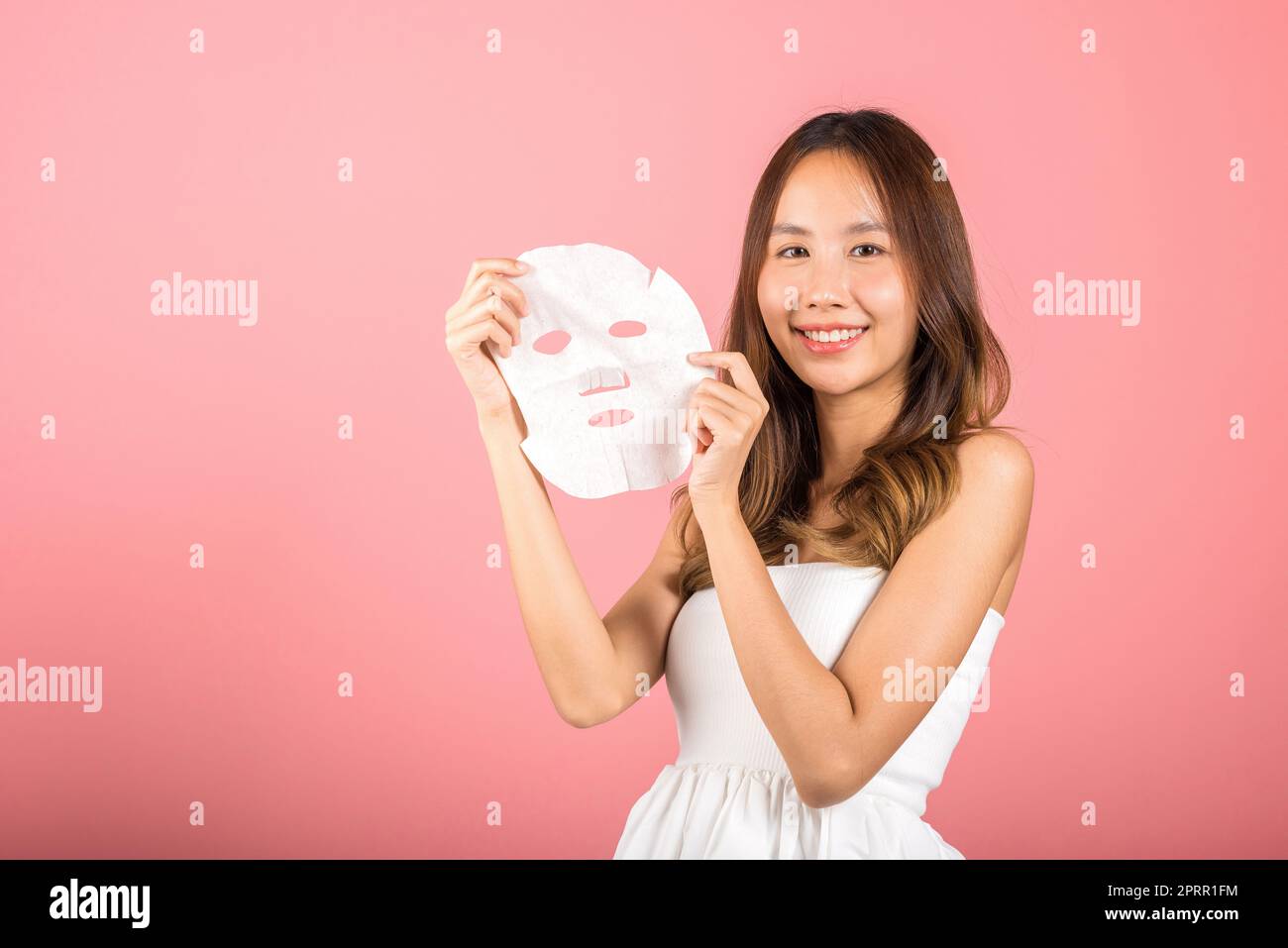 Portrait beautiful female smiling holds facial sheet mask Stock Photo ...