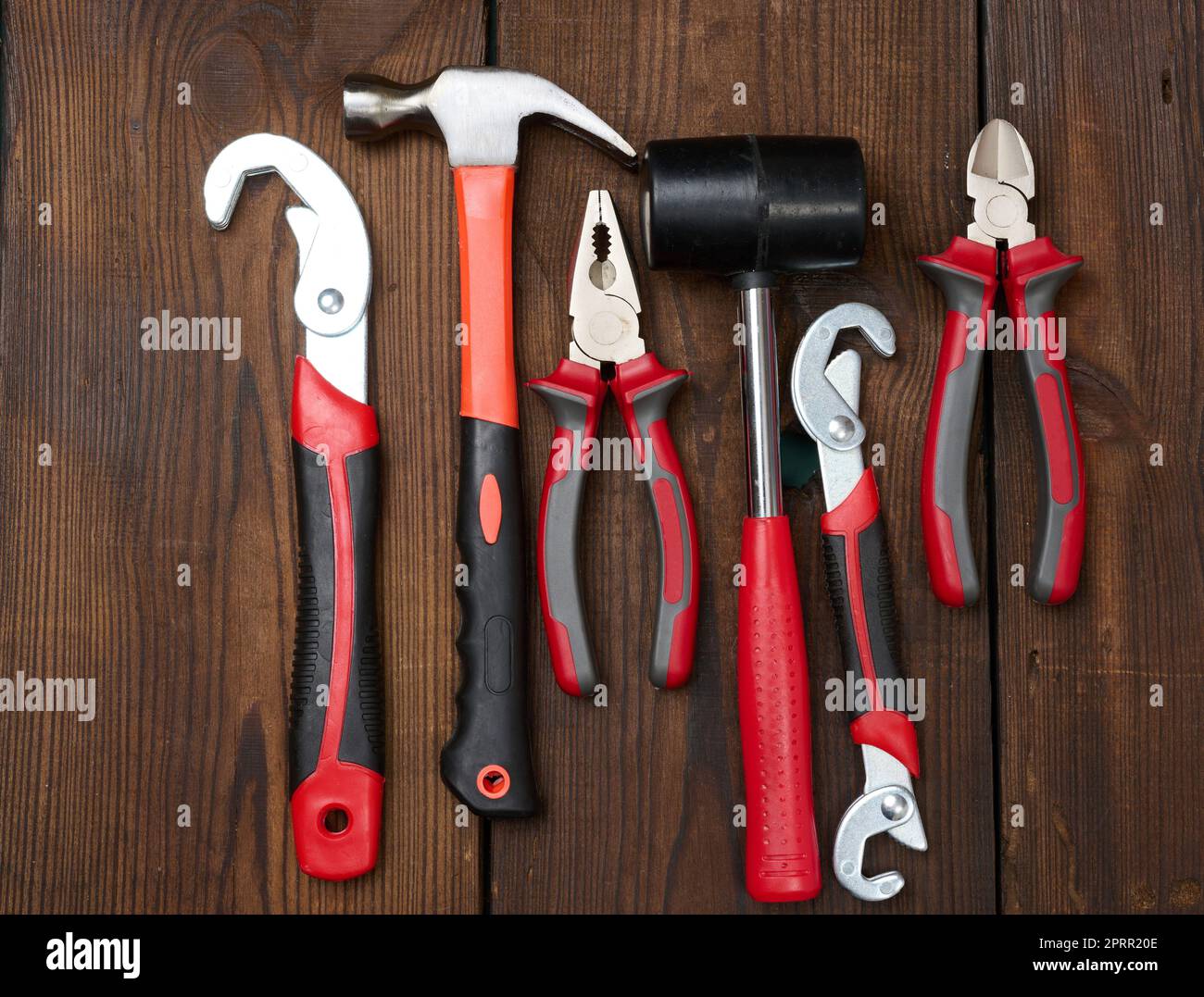 A set of construction tools on a brown wooden background, top view ...