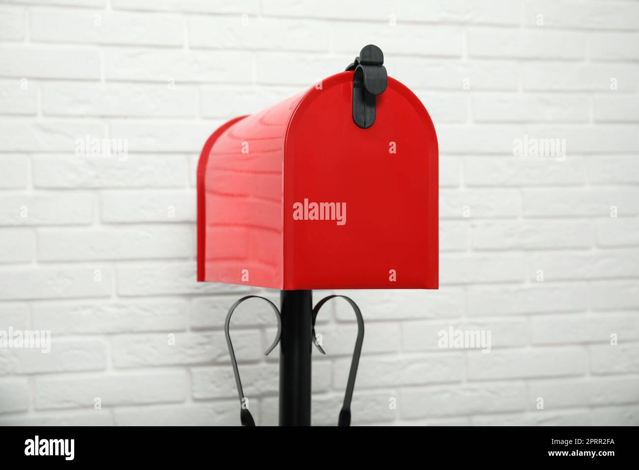 Closed red letter box near white brick wall Stock Photo - Alamy