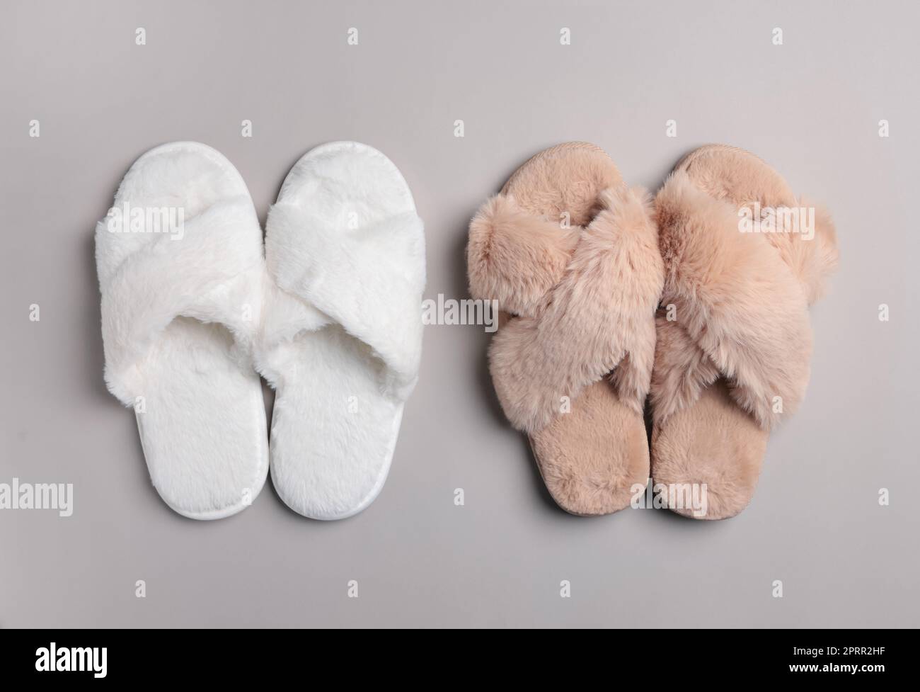 Different soft fluffy slippers on light grey background, flat lay Stock ...