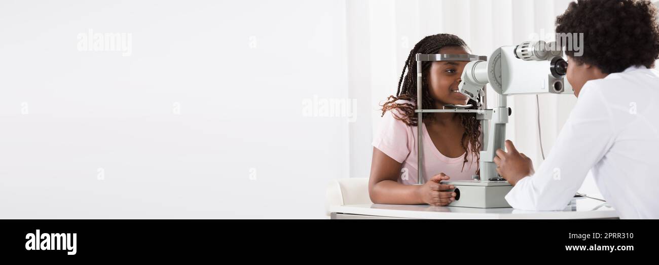 Optometry Eye Exam. African Optician And Patient Stock Photo - Alamy