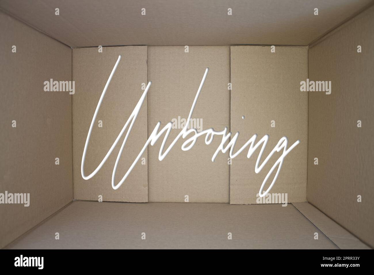 Unboxing word with cardboard box. Brown folded card box Stock Photo - Alamy