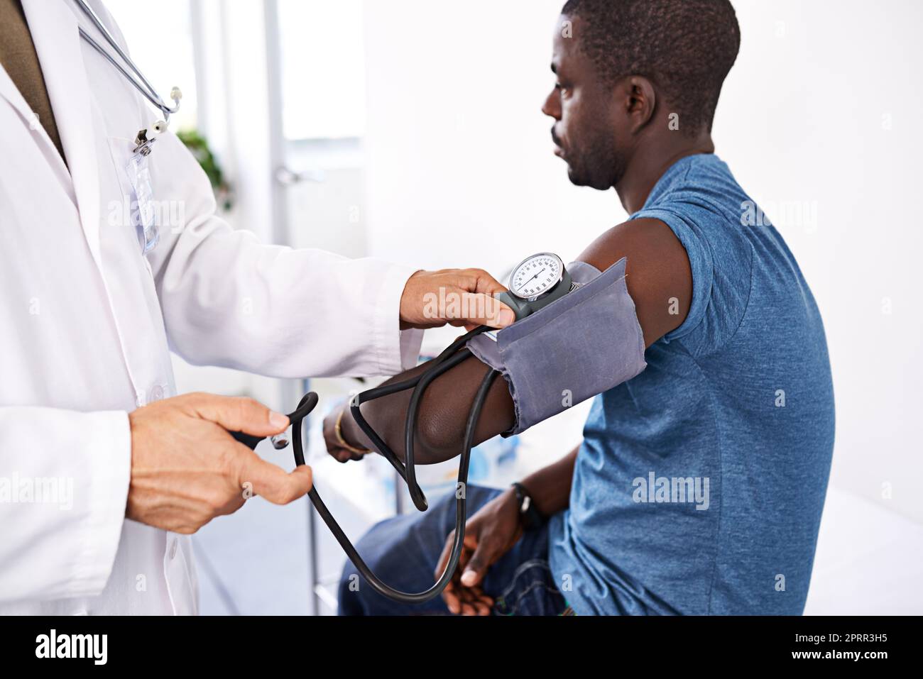 Feeling under pressure. a doctor taking a male patients blood pressure ...