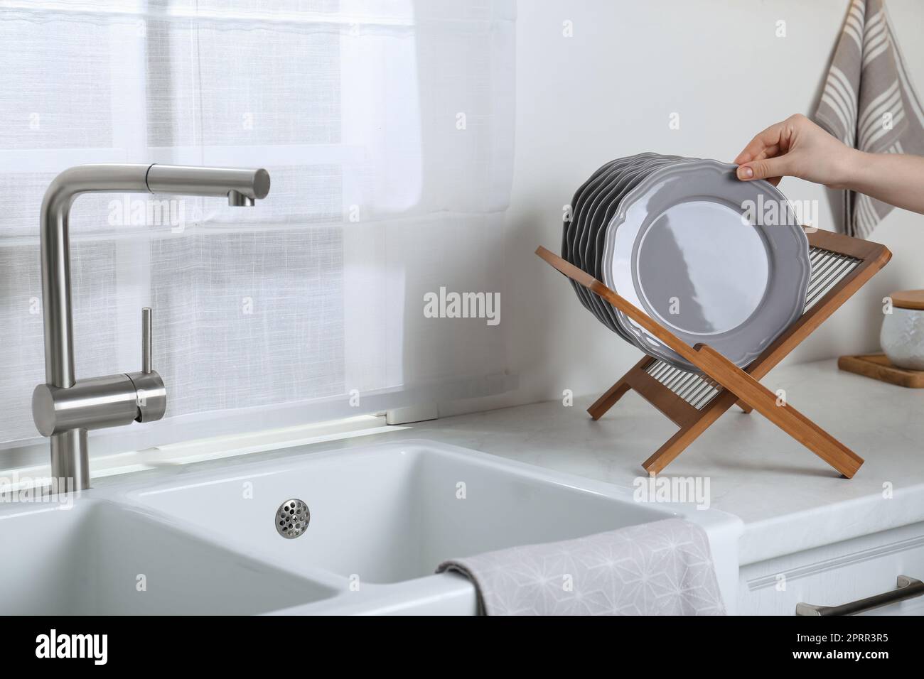 Woman taking grey plate hi-res stock photography and images - Alamy