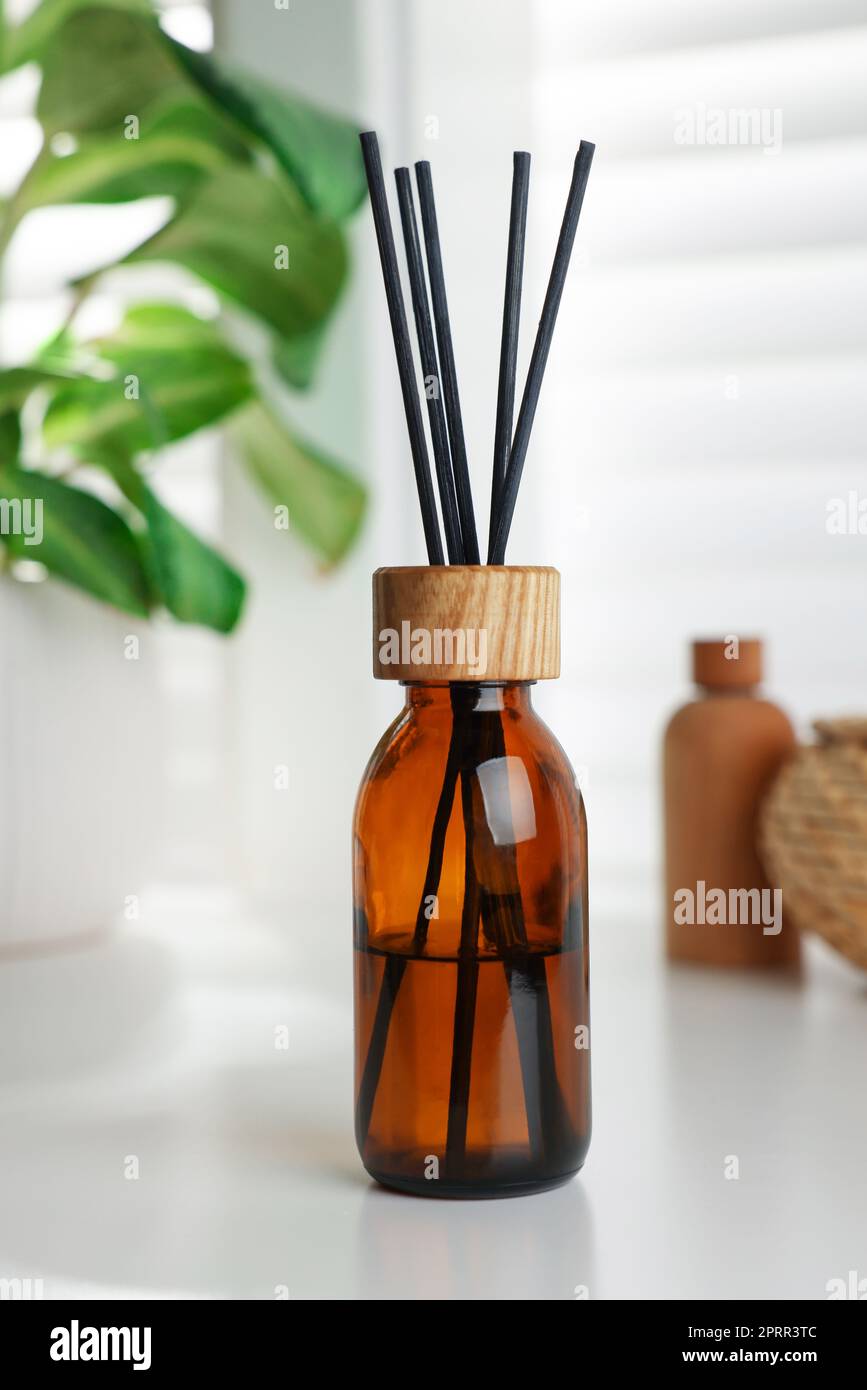 Air reed freshener on white table near window Stock Photo - Alamy