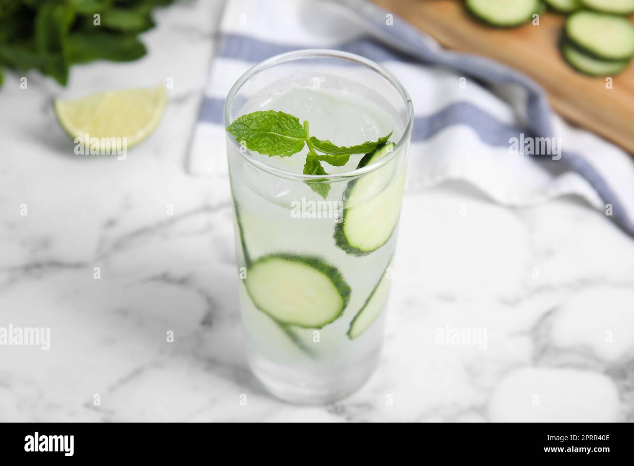 Glass of refreshing cucumber water with mint on white marble table Stock Photo - Alamy
