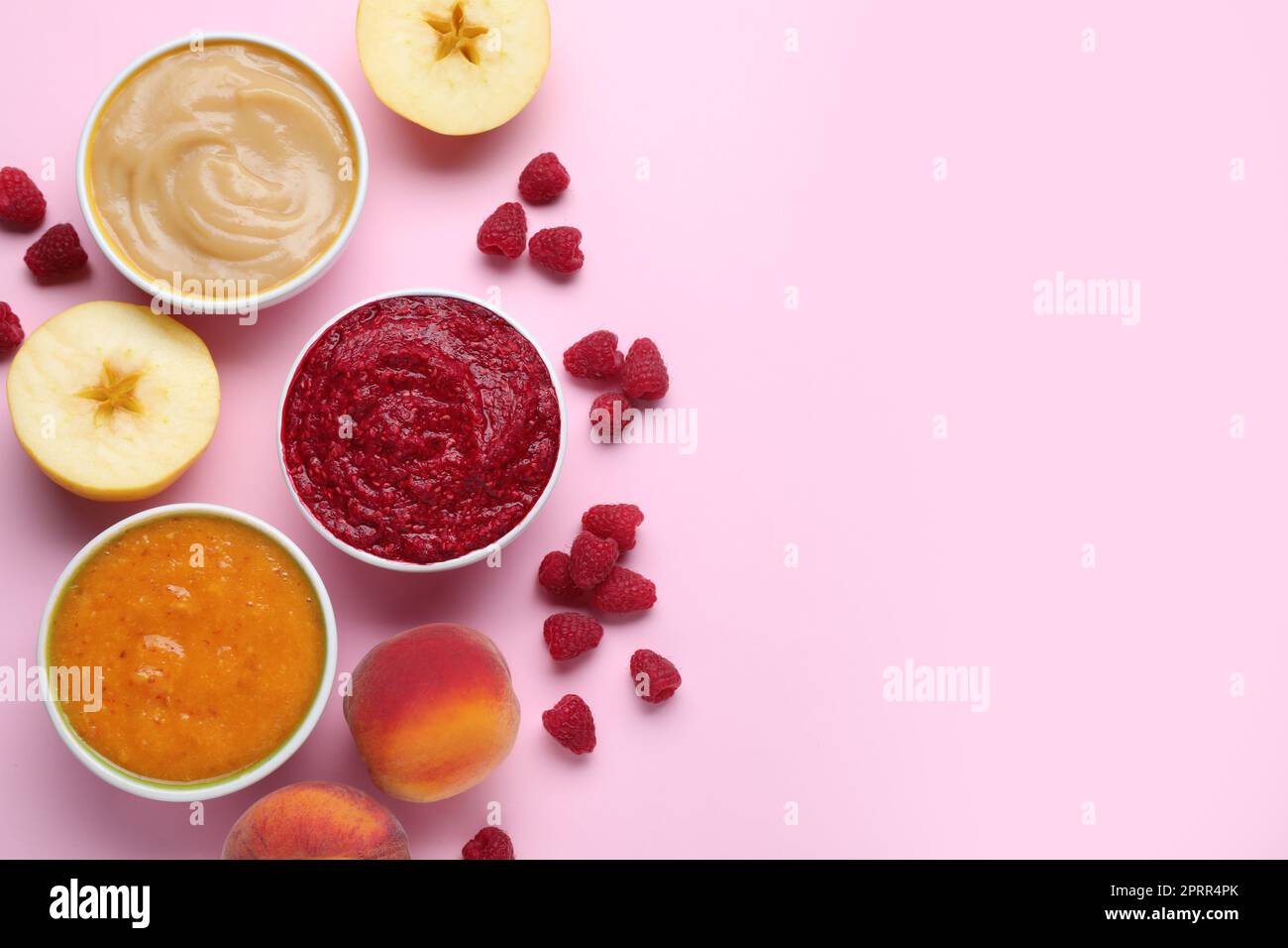 Different puree in bowls and fresh ingredients on pink background, flat ...