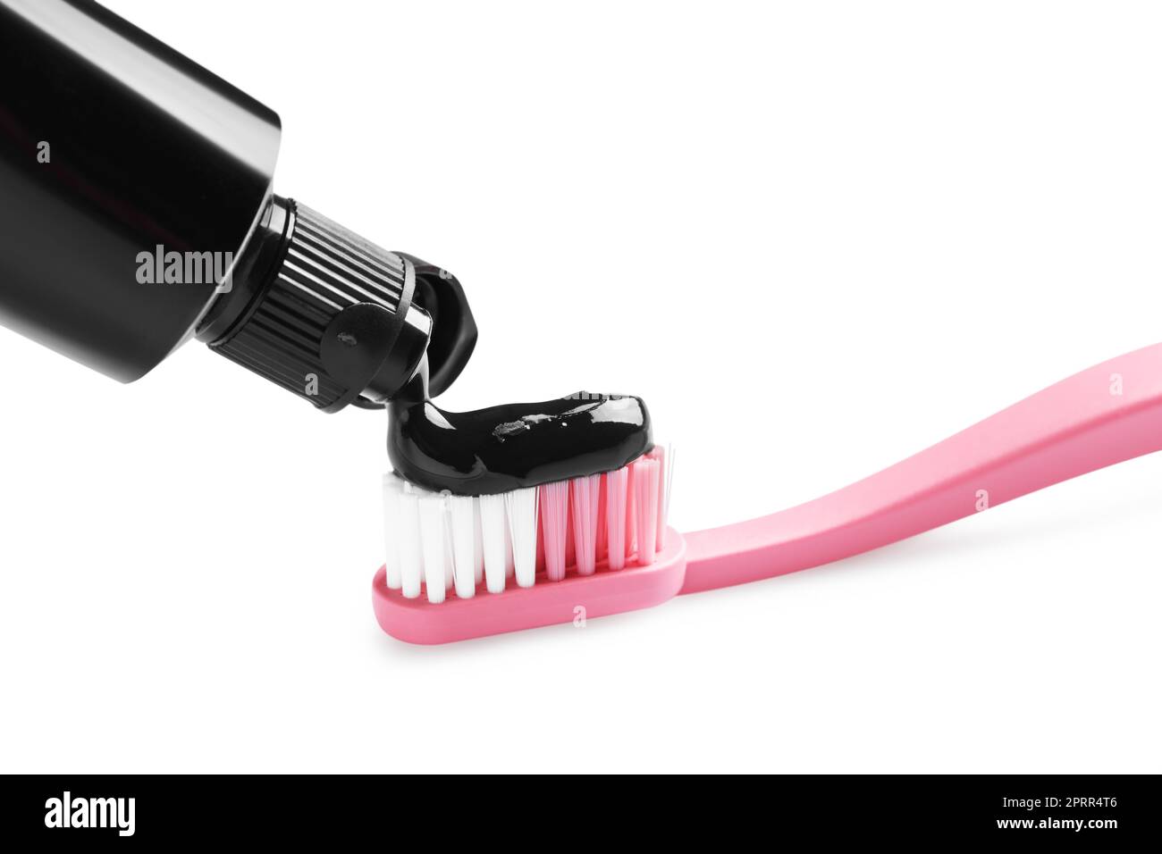Tube of charcoal toothpaste and brush on white background Stock Photo ...
