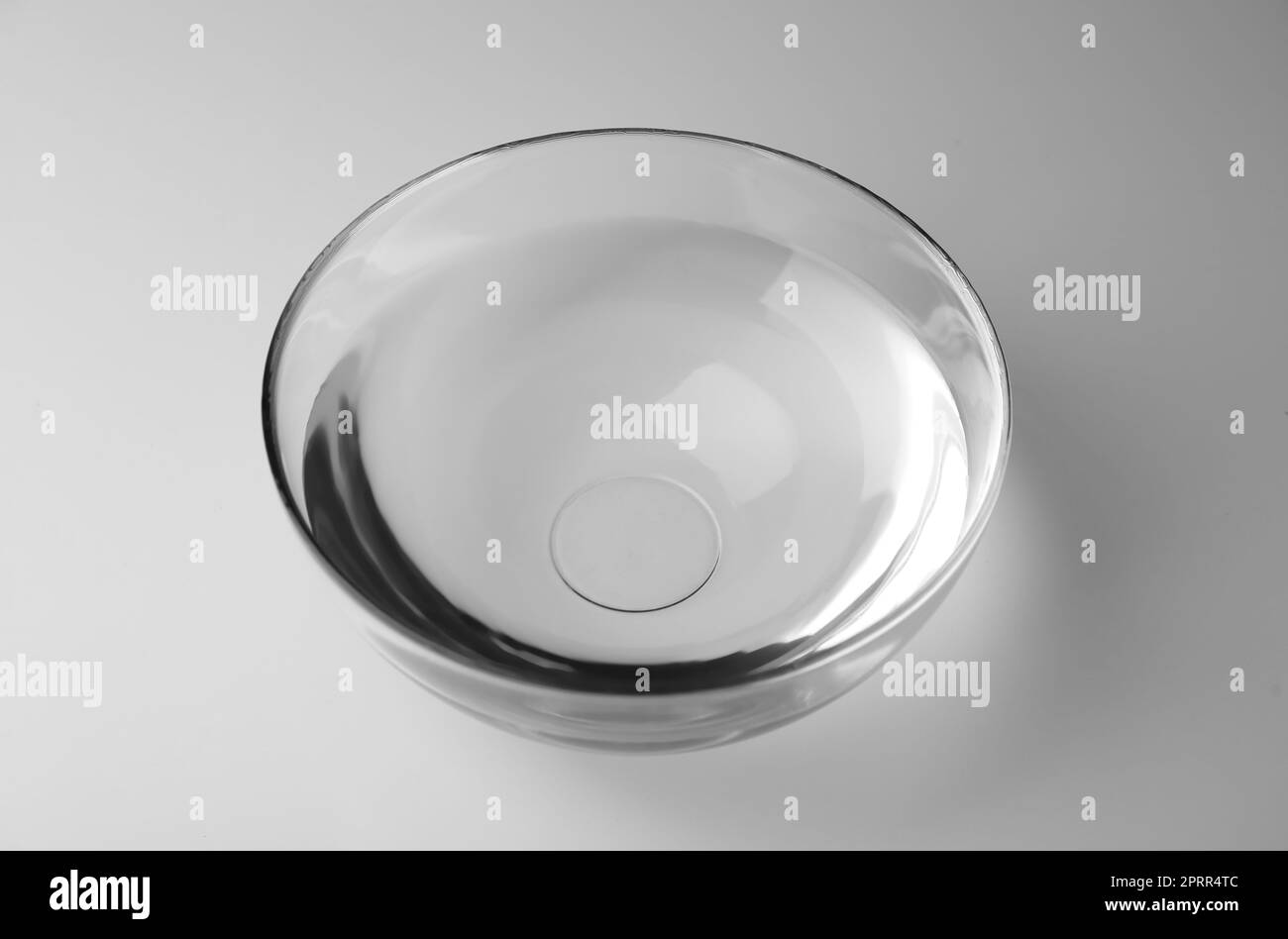 Glass bowl full of water on white background Stock Photo - Alamy