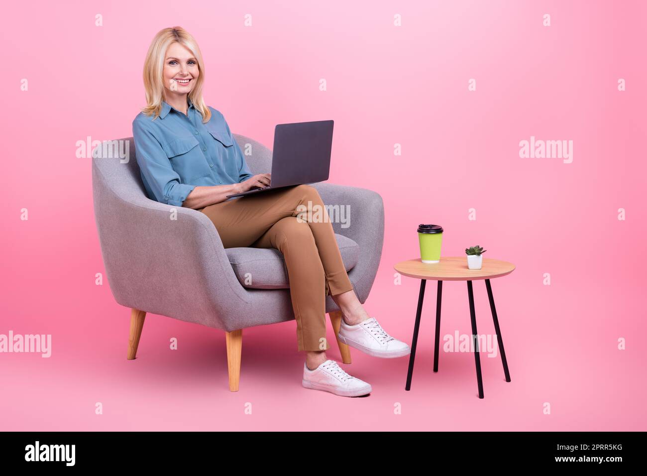 Photo of attractive confident senior lady worker use netbook sit ...