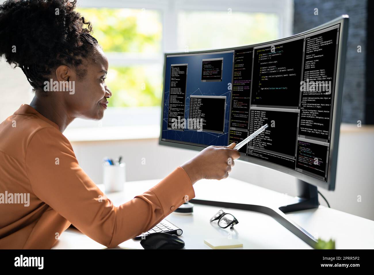 Computer Programmer Writing Program Code On Computer In Office Stock ...