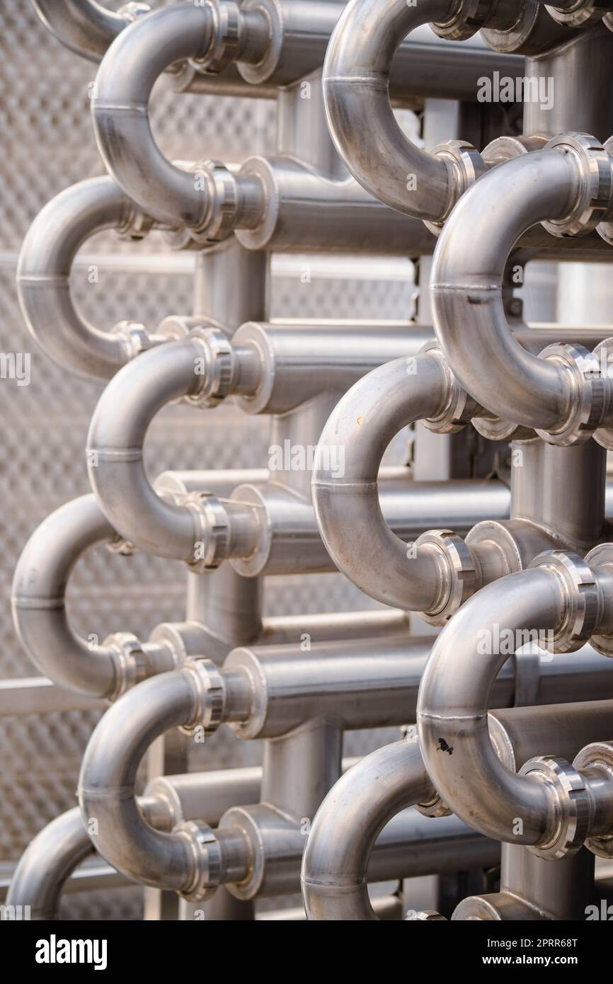 Close up shot of many alloy inox pipes in a factory Stock Photo - Alamy