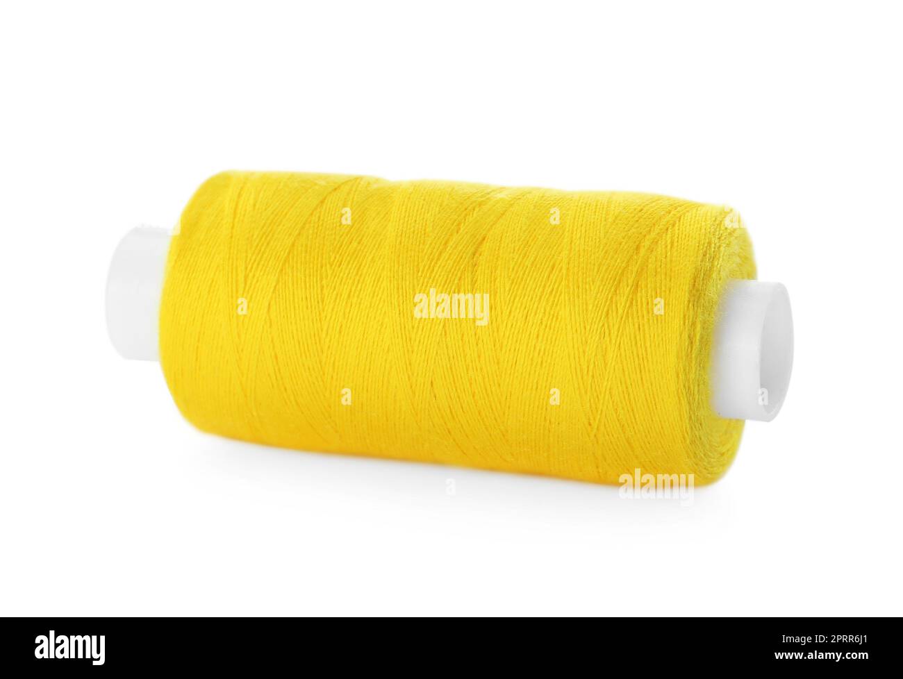 Spool of yellow sewing thread isolated on white Stock Photo - Alamy