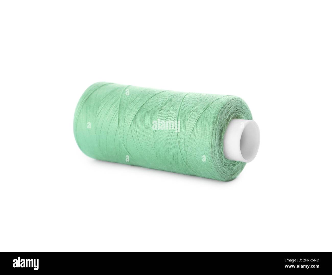Spool of light green sewing thread isolated on white Stock Photo - Alamy