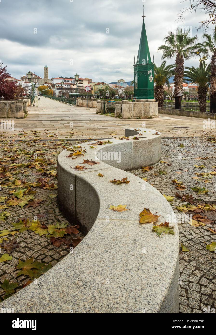 Curved stone bench leading the eye towards the entrance to the medieval ...