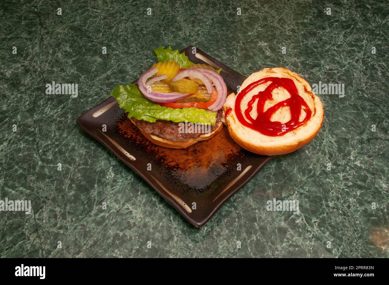 Delicious hamburger with all the fixings on a bun Stock Photo - Alamy