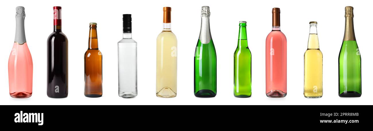 Set with bottles of different alcohol drinks on white background ...