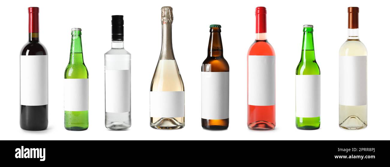 Set with bottles of different alcohol drinks on white background ...