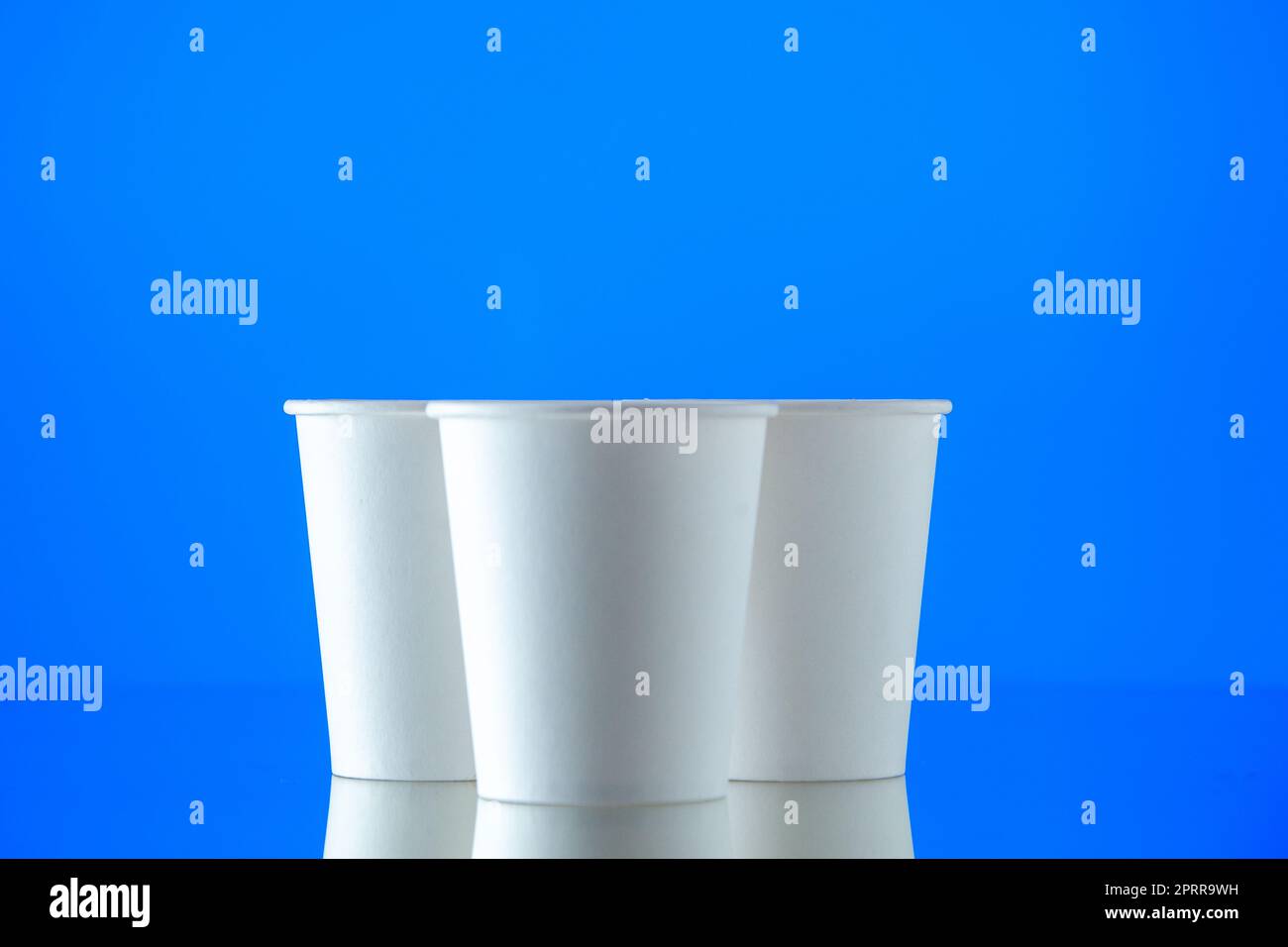 front view paper water cups on blue background free space Stock Photo ...