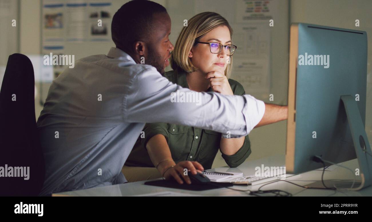 Tell me about this...two businesspeople working together on a computer ...