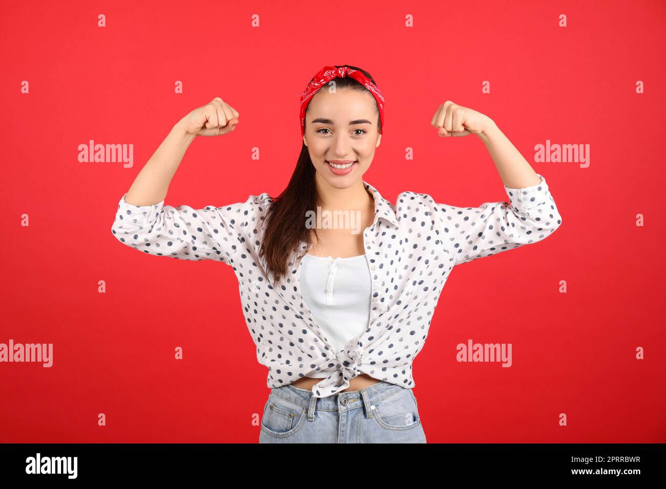 Strong woman as symbol of girl power on red background. 8 March concept ...