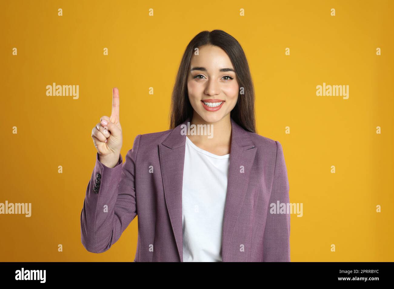 Woman in violet blazer showing number one with her hand on yellow ...