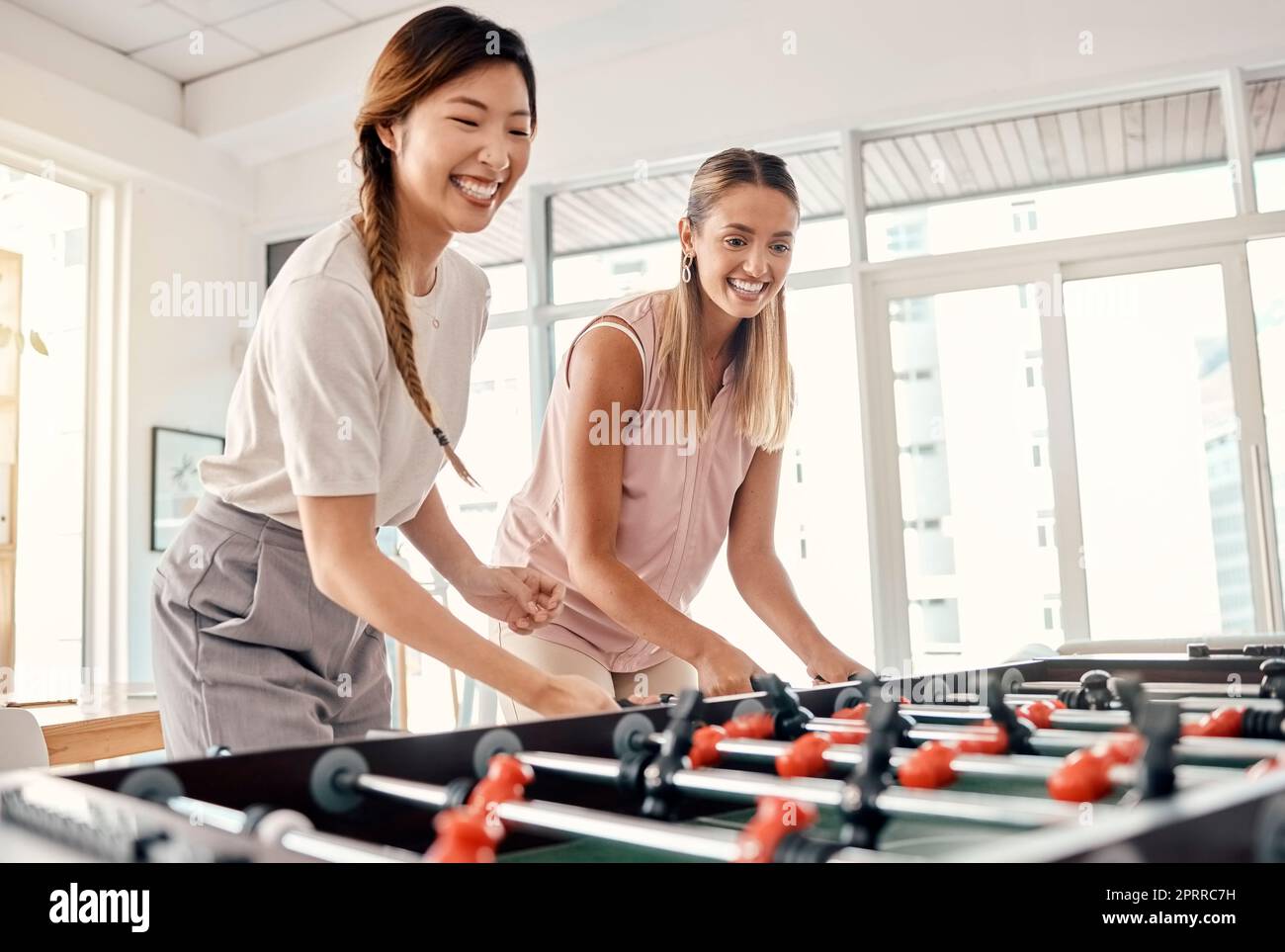 Happy friends playing table football hi-res stock photography and ...