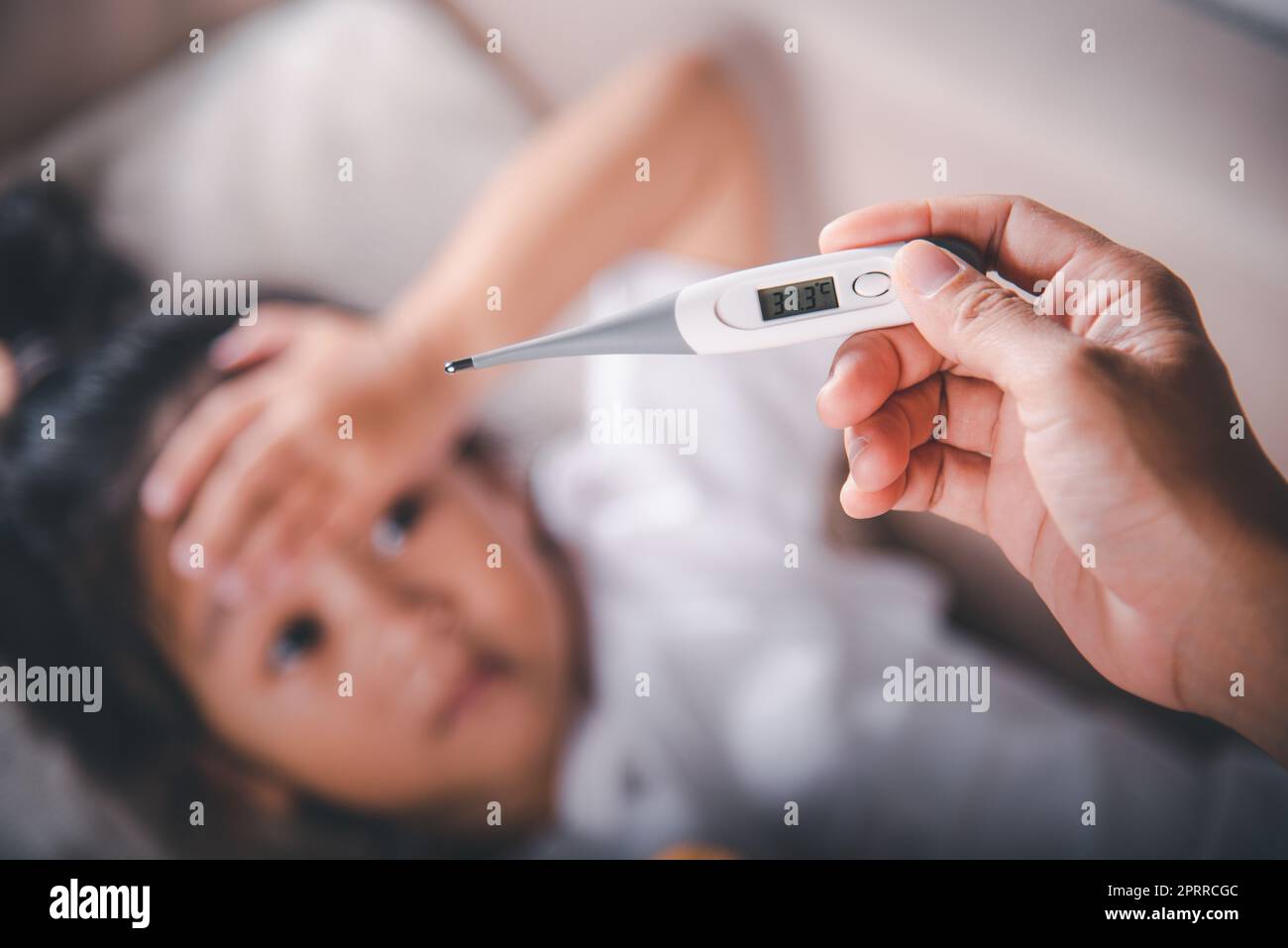 Sick kid. Mother checking temperature of her sick daughter with thermometer in mouth, child ...