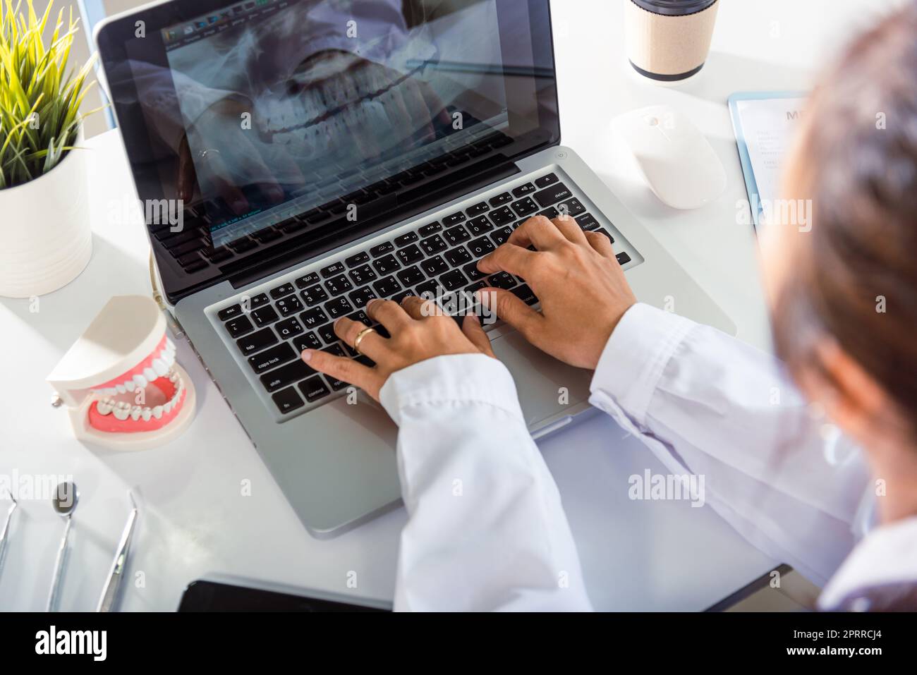 Dentist doctor or nurse in uniform use oral software teeth Xray and ...