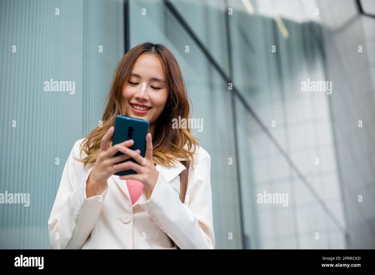 Asian businesswoman texting smartphone commuting work she walking near ...