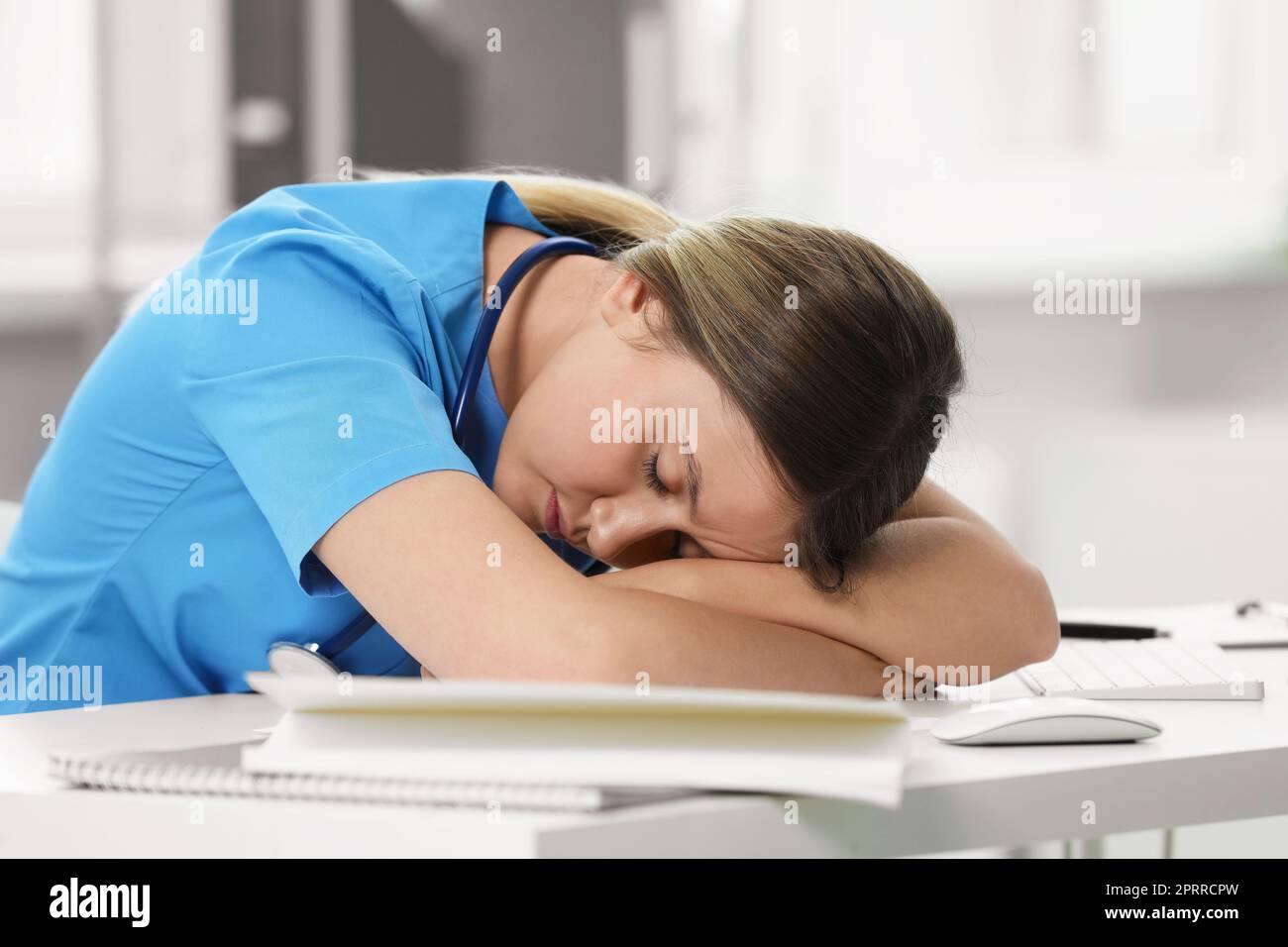Exhausted doctor sleeping at workplace in hospital Stock Photo - Alamy