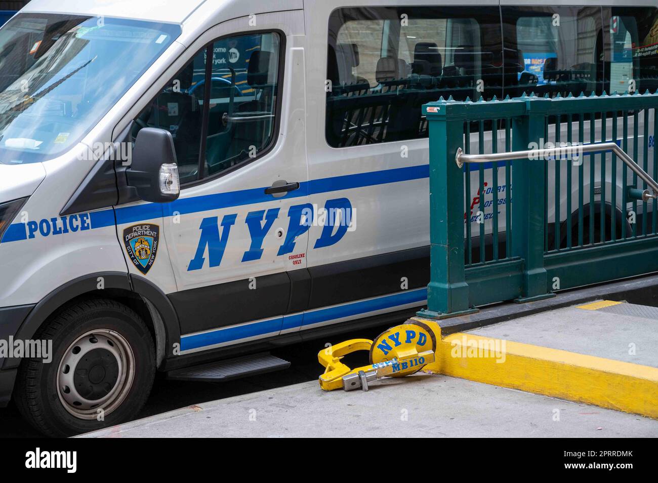 NYPD New York Police Department van and car boot by subway antrance ...