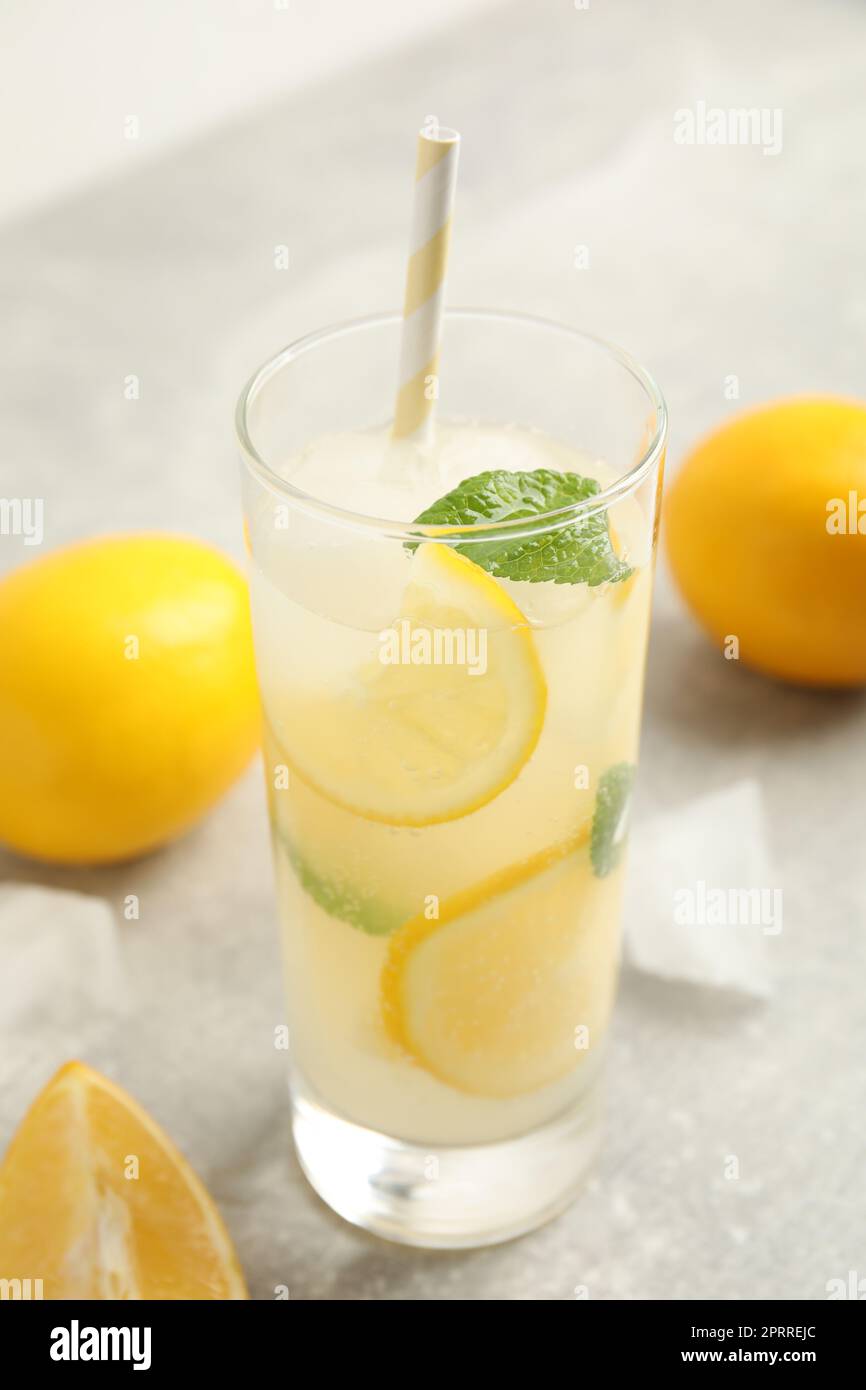 Cool freshly made lemonade, ice cubes and fruits on grey table Stock Photo - Alamy
