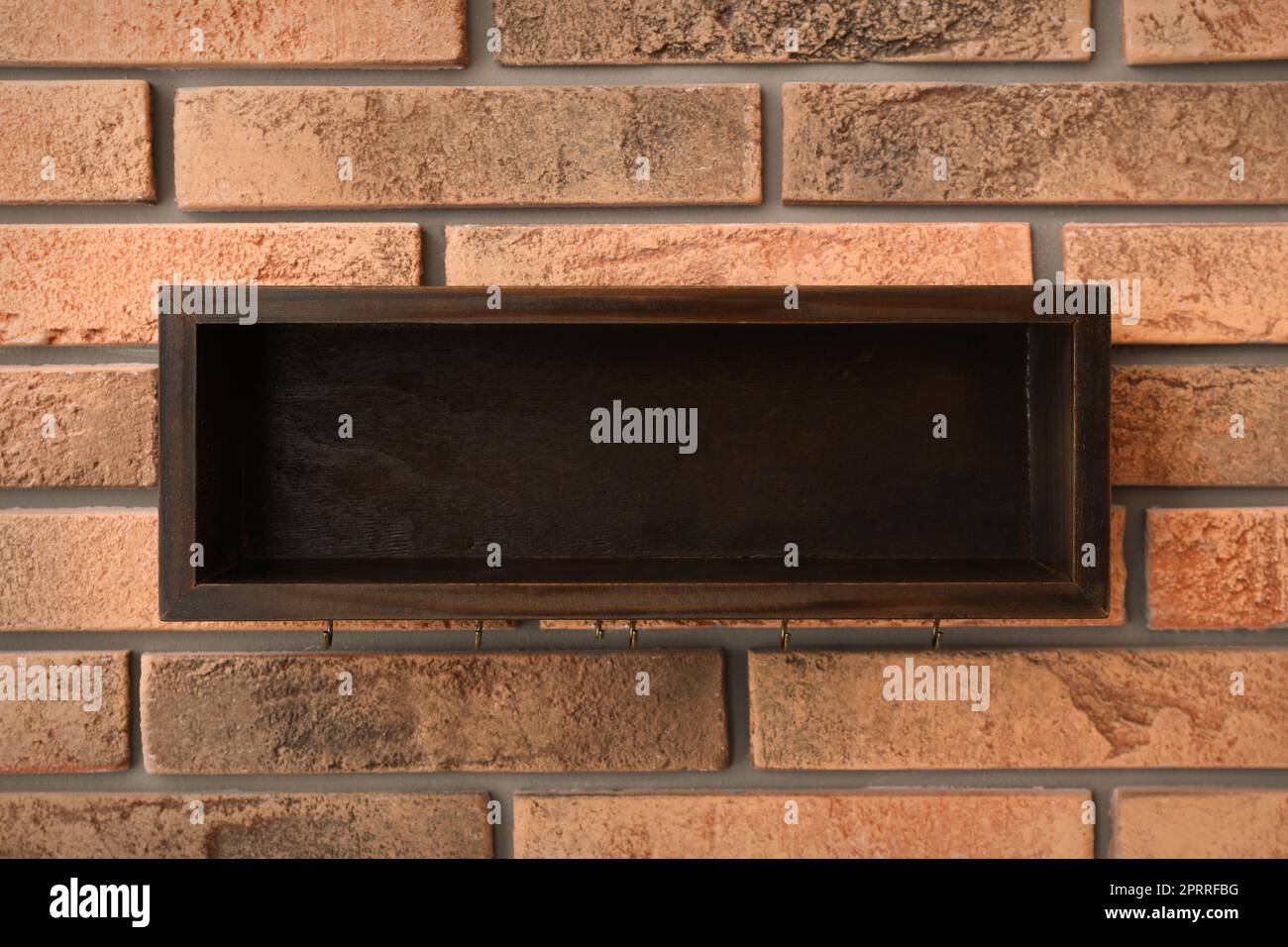 Empty wooden shelf with hanger for keys on brick wall Stock Photo - Alamy