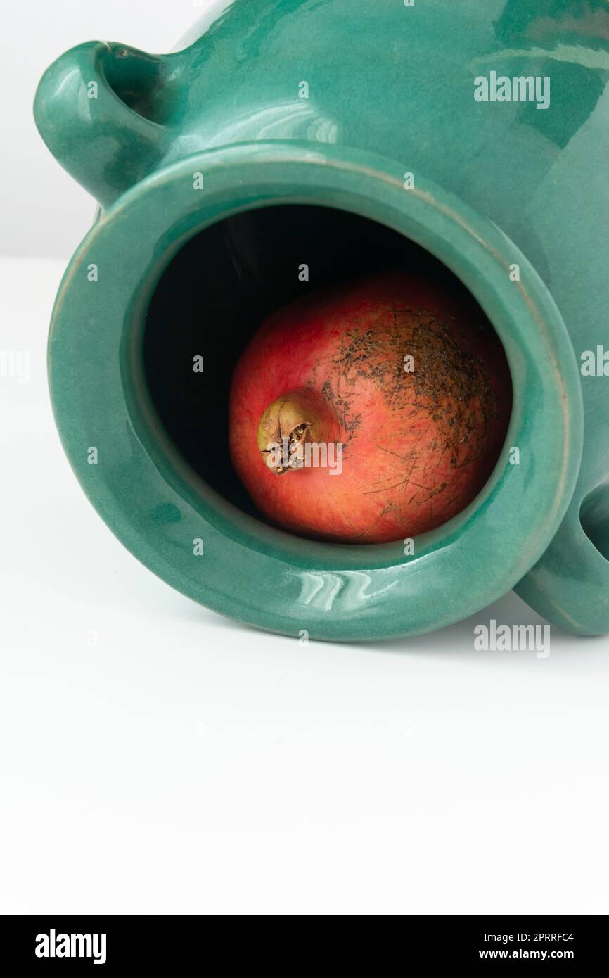 A pomegranate inside clay earthen ware Stock Photo - Alamy