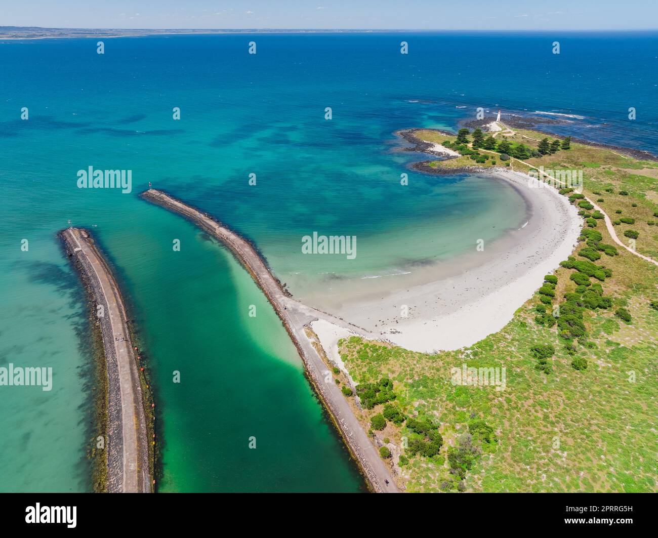 Aerial view of a turquoise ocean off a white sandy beach on Griffith's ...