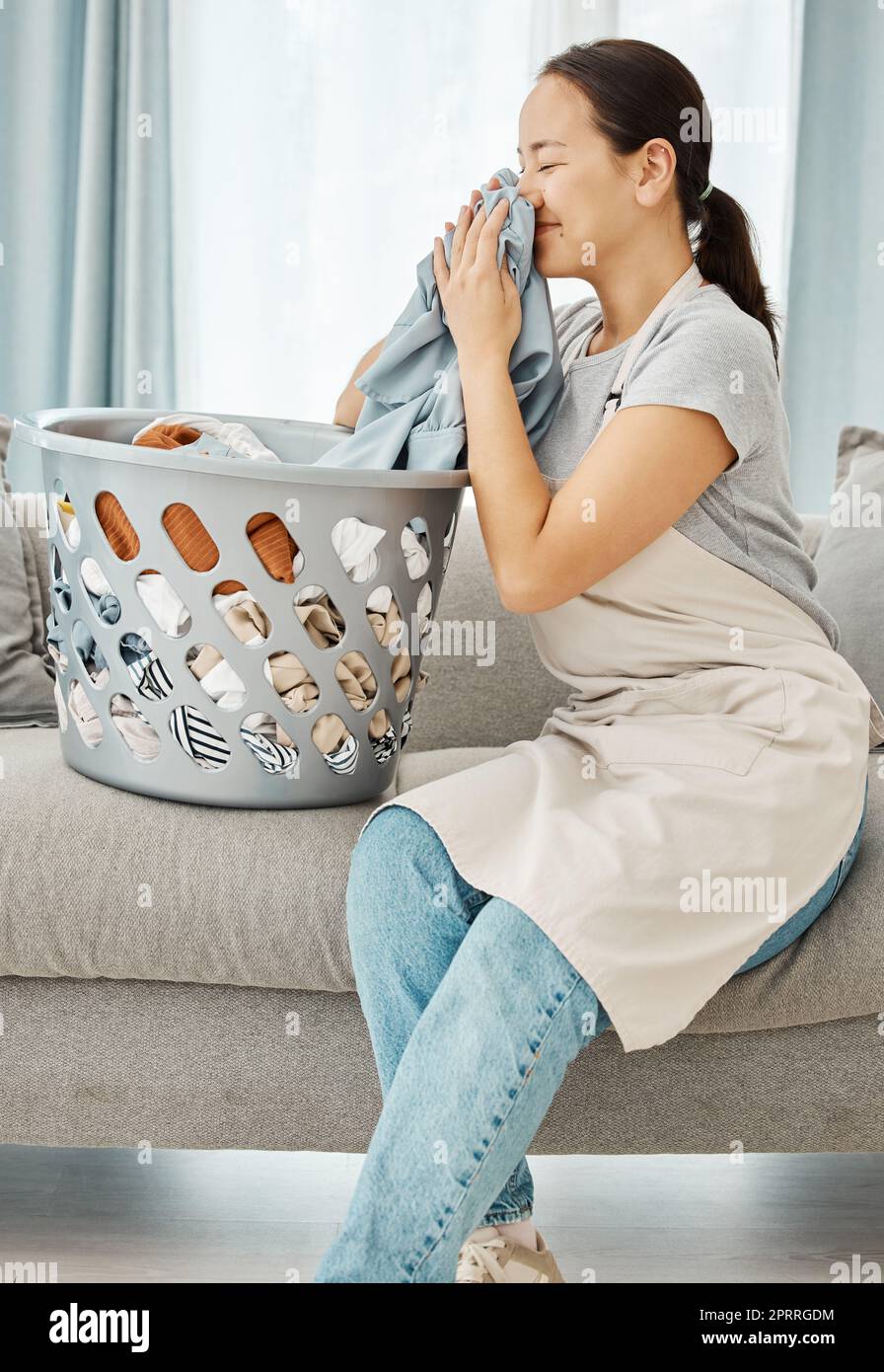 Clean laundry, happy woman and smelling fabric, fresh scent of clothes ...