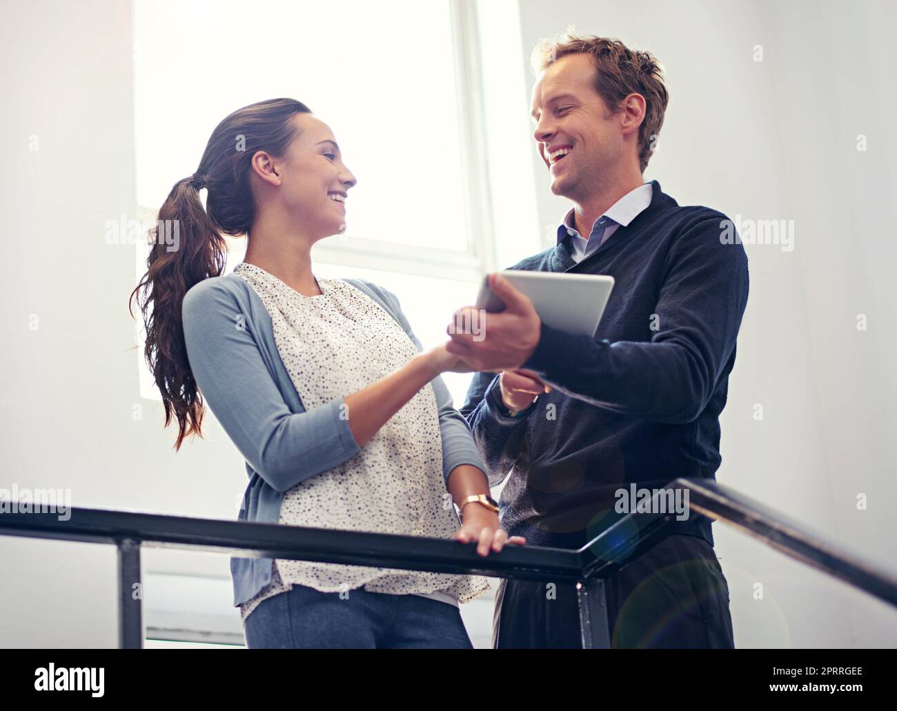 Scheduling on the move. two colleagues using a digital tablet while ...