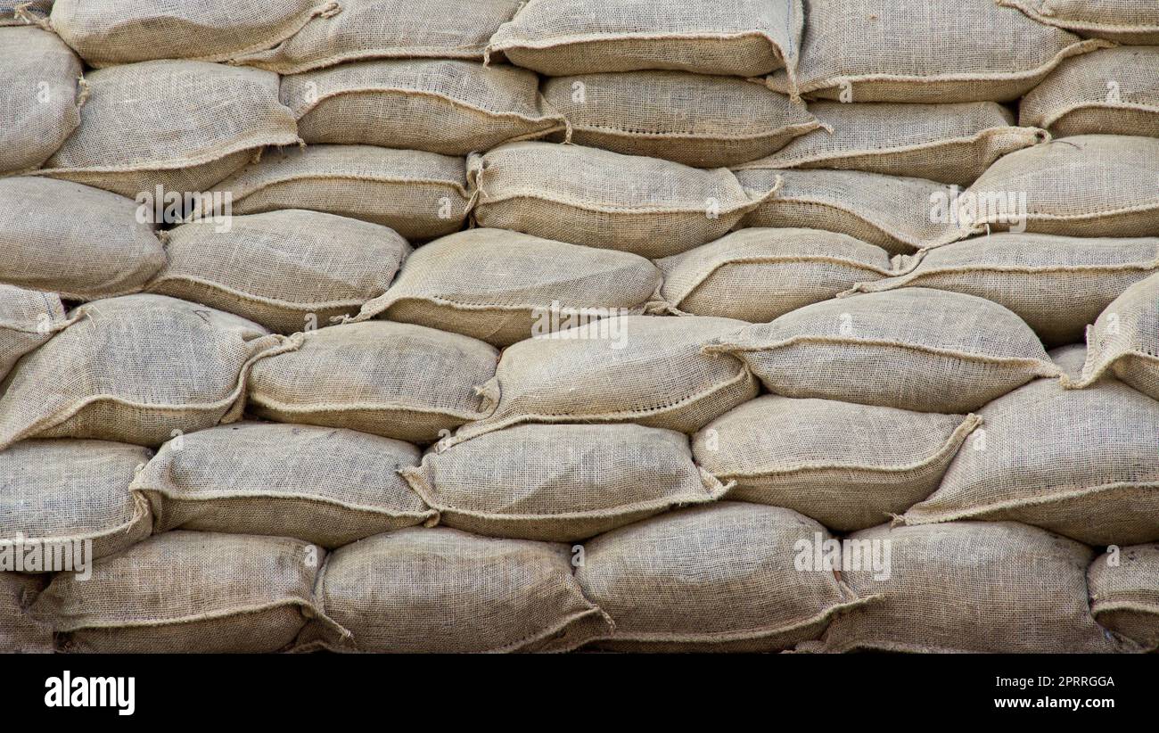 Background of lying dirty sandbags. Sandbag flood protection wall ...