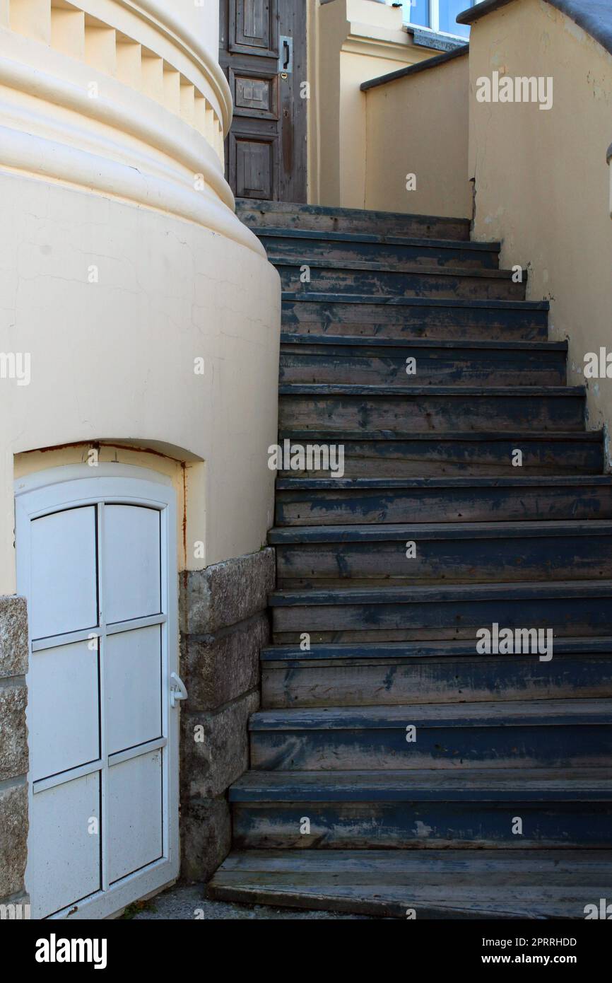 Entrance staircase of an old building made of light stone. Ancient city ...
